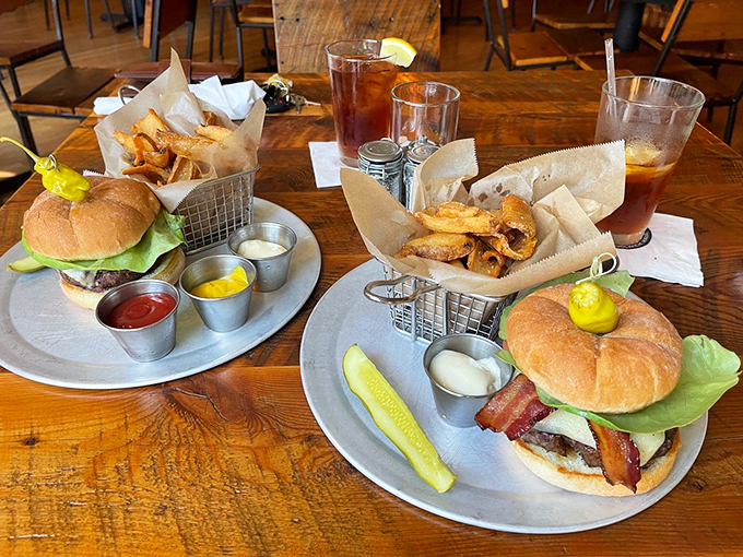 Classic burgers done right, with golden fries and those little metal sauce cups that make everything feel fancy.