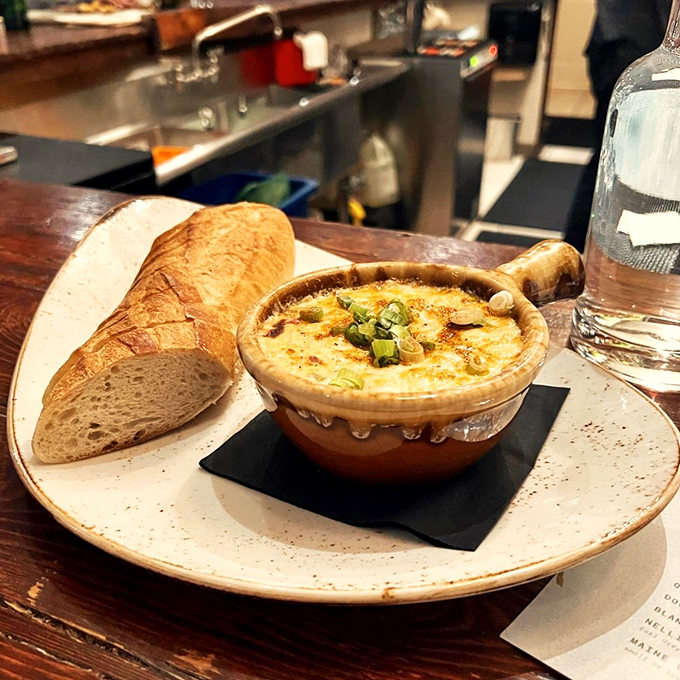 Bubbling crab dip alongside crusty bread - because sometimes happiness comes in a ceramic crock.