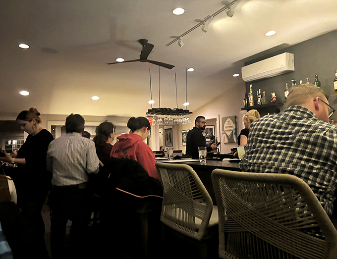 Happy diners in their natural habitat. Notice how they lean in, as if the food might whisper secrets of culinary nirvana.