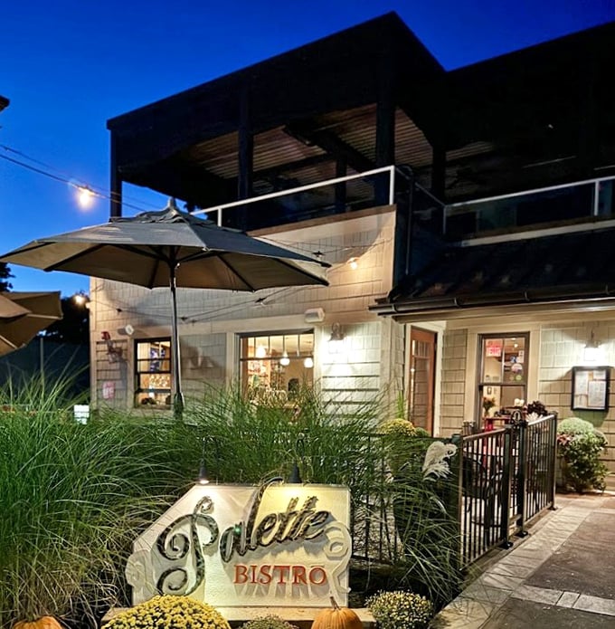 As evening falls, the bistro glows like a welcoming lighthouse, with autumn decorations adding seasonal charm.