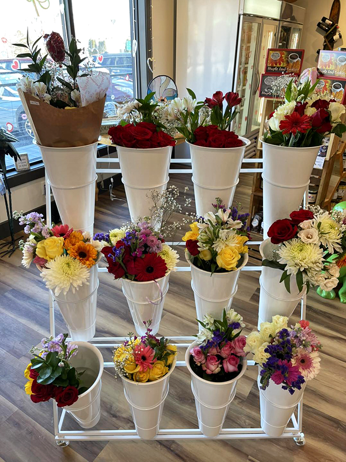 A burst of color greets visitors with fresh flowers arranged in pristine white vessels, bringing Vermont's garden beauty indoors.