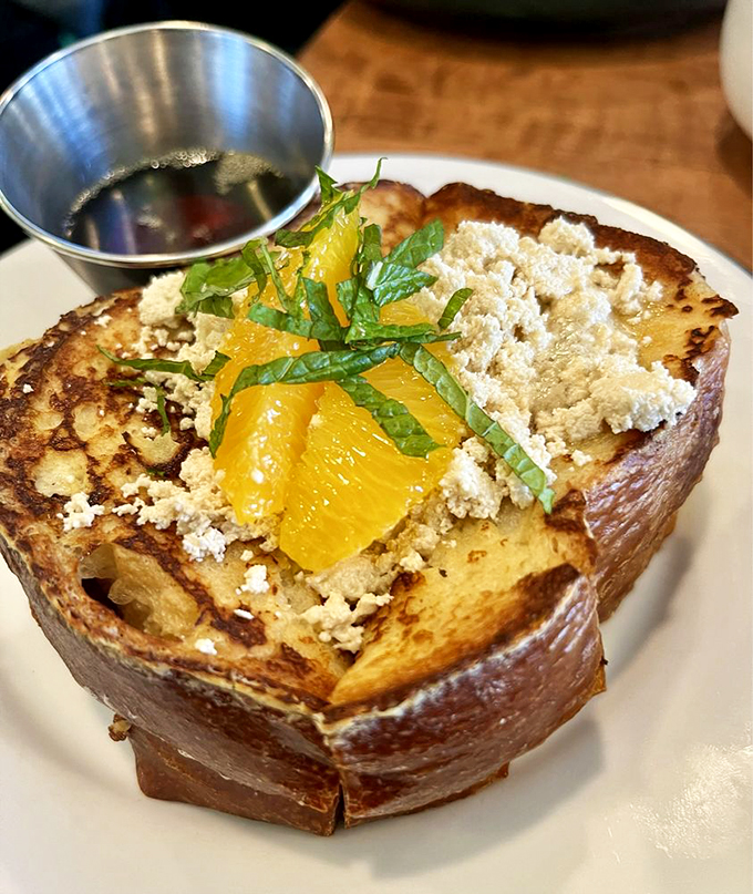 Golden-brown French toast adorned with citrus and halva - breakfast that thinks outside the maple syrup box.