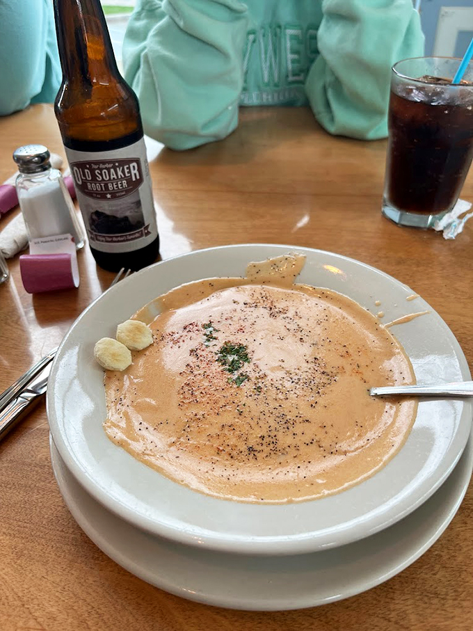 This lobster bisque isn't just soup - it's a warm hug in a bowl, topped with fresh herbs like nature's confetti. Photo credit: Joe S
