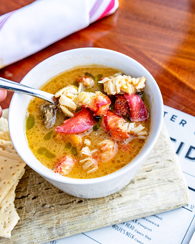 Rich, golden lobster stew that looks like liquid sunshine, studded with generous chunks of Maine's finest.