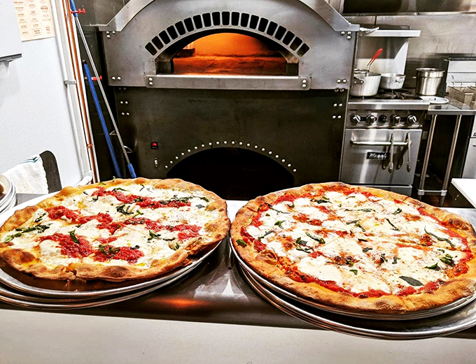 Fresh from the brick oven, these pies are like twins competing for your attention. Both are winning.
