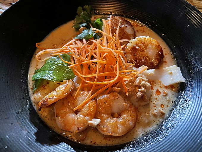 This seafood stew, crowned with crispy carrots, brings together land and sea in one steaming bowl of comfort. Photo credit: Oso L.