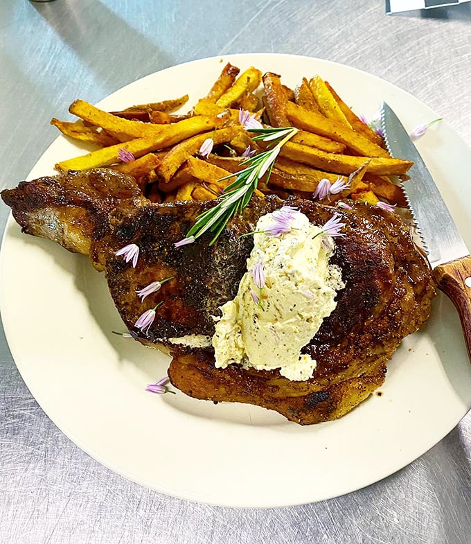 A masterpiece of meat and potatoes, elevated with compound butter and sweet potato fries that steal the show.