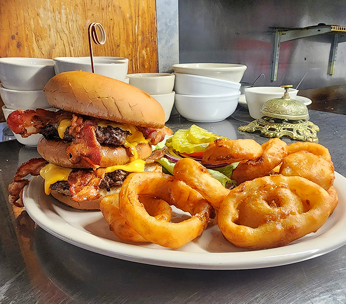 Holy cow! This burger is stacked higher than a Jenga tower. It's a delicious balancing act that's worth every napkin. Photo credit: Beeline Cafe