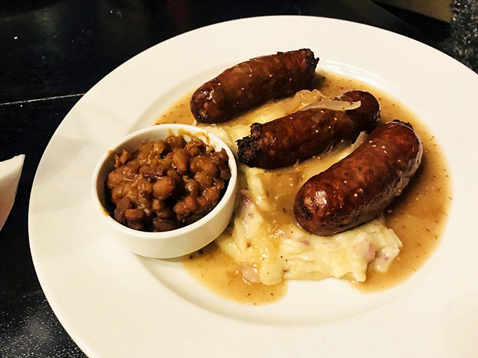 Bangers and mash: where sausage meets its potato soulmate. Add a lake of gravy and a side of baked beans, and you've got comfort on a plate. Photo credit: Nova J.