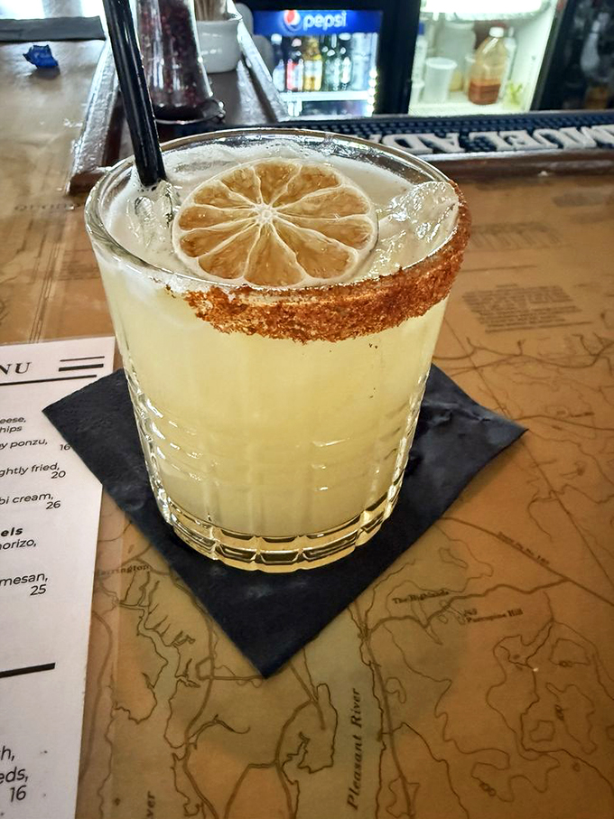 A cocktail that's dressed to impress, with a salt rim fancier than a lobster's bow tie. It's sunshine in a glass, with a kick.