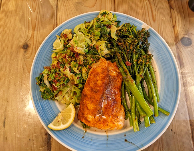 Green eggs and ham? Nah, we've got grouper and greens! This plate is so colorful, it's like a Picasso painting you can eat.