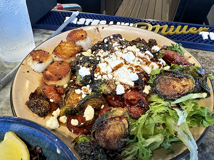 Scallops that sizzle and Brussels that pop! This plate is a testament to the magic that happens when land and sea come together in perfect harmony. Photo credit: Trey Butler