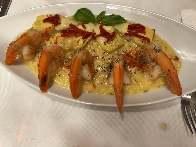 Shrimp lounging on a bed of creamy risotto - it's like a five-star resort vacation for your taste buds.