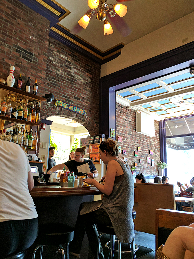 Where industrial meets cozy &ndash; exposed brick arches frame a space that feels like Portland's living room. 