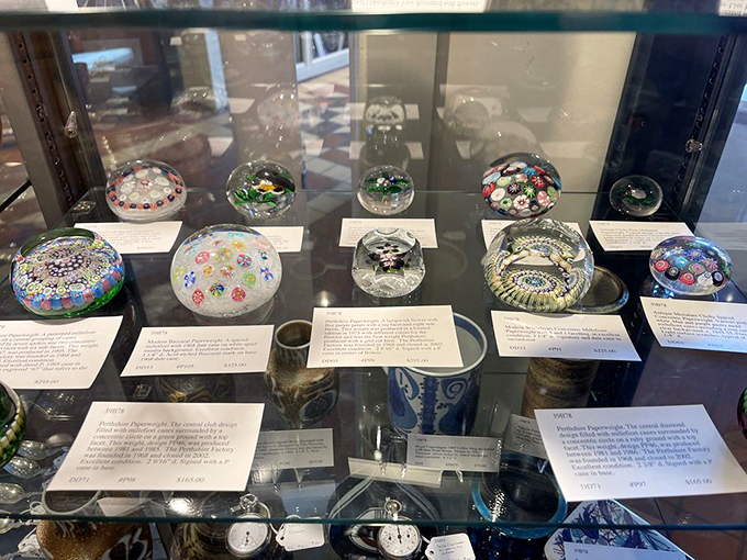 Delicate paperweights hold worlds within their glass domes, each one a miniature universe of color and craft. Photo credit: Mick M.