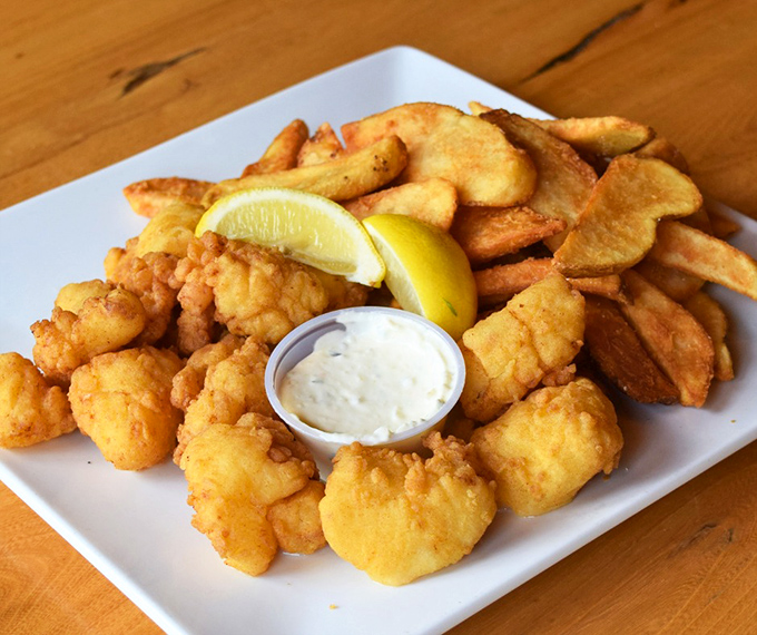 Golden-battered scallops that crunch like nature's candy, served with house-made tartar sauce and wedge fries.