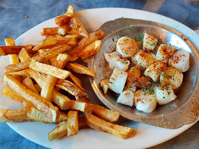 These scallops got the golden treatment - perfectly seared and ready to steal the show from those crispy fries.