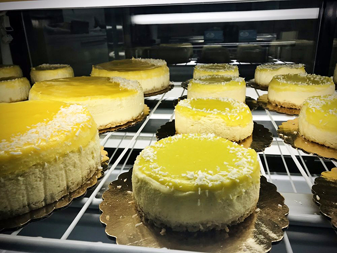 A battalion of key lime cheesecakes standing at attention, each crowned with a halo of coconut.