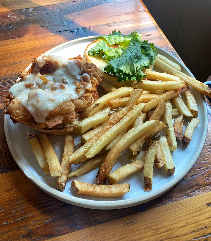 A towering creation of crispy chicken and melted cheese that requires a game plan before the first bite.