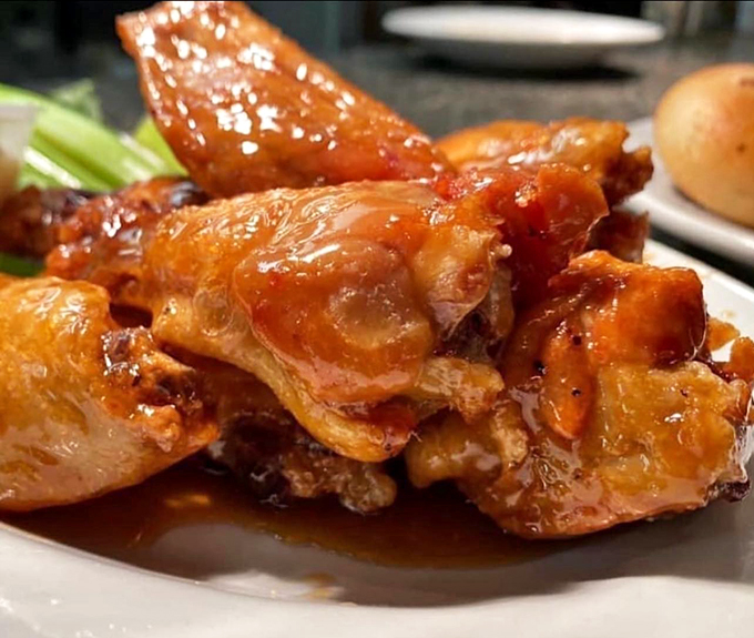 These wings, glistening with sauce, aren't just wings &ndash; they're proof that sometimes the best seafood restaurants have excellent landlubber options.