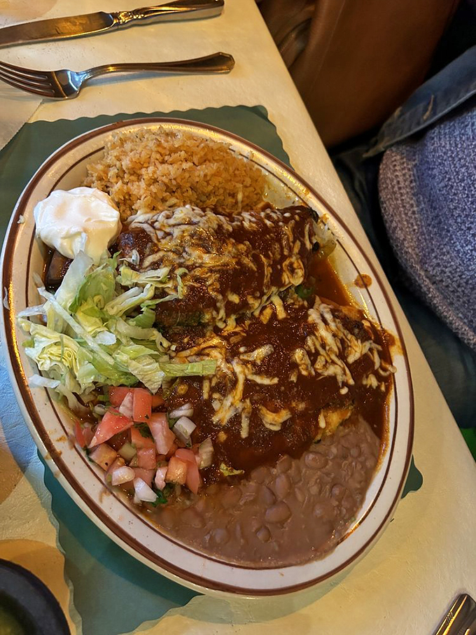 Comfort food gets dressed up: these enchiladas swim in rich sauce while rice and beans stand ready to soak up every drop.