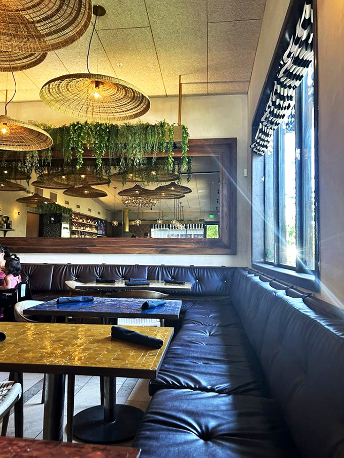 Plush leather seating and warm lighting create the perfect spot for sharing both pizzas and stories.