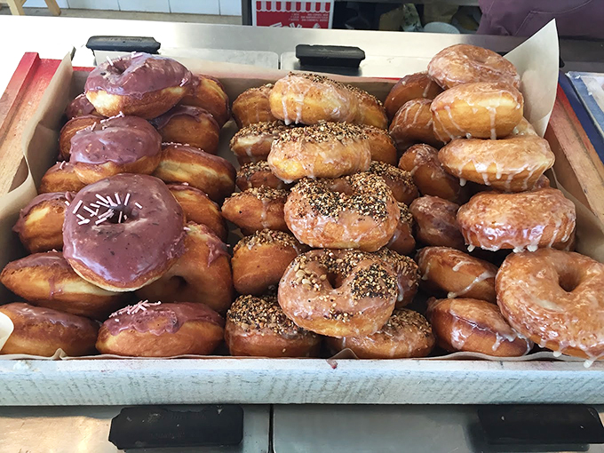 A rainbow of glazed, sprinkled, and sugar-dusted donuts that would make Homer Simpson weep with joy.
