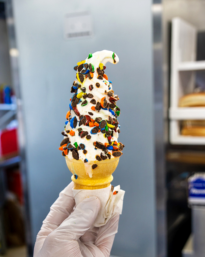 Vanilla soft-serve decorated with chocolate chips and sprinkles - like a party hat for your taste buds.