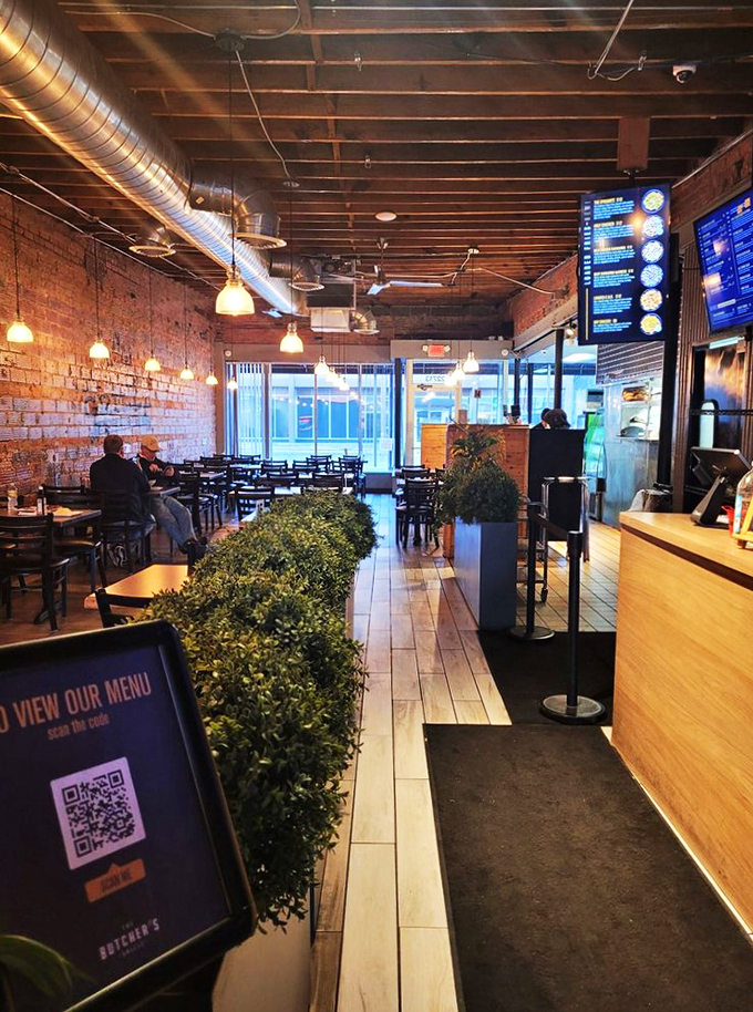 Where industrial meets inviting: exposed ductwork and warm lighting create the perfect dining backdrop.