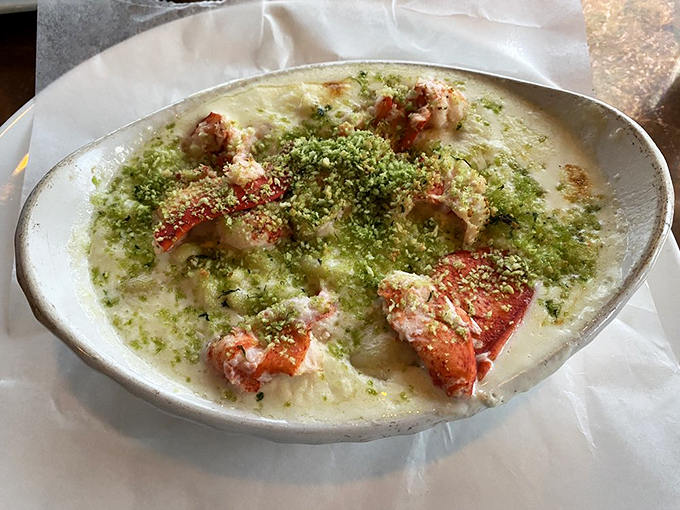 Lobster mac and cheese that's dressed to impress, with a green herb crust that adds both style and substance. Photo credit: Jan C.