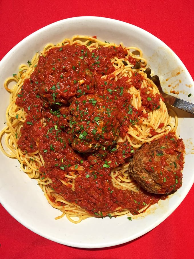 Spaghetti and meatballs: the Batman and Robin of Italian cuisine. This plate is so classic, it should come with its own Frank Sinatra soundtrack.