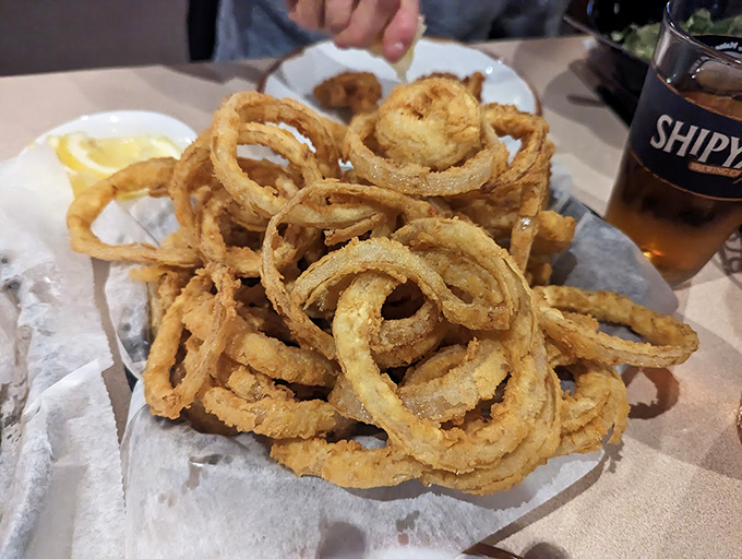 Crispy onion rings stacked like delicious golden halos – because sometimes sides deserve the spotlight too.