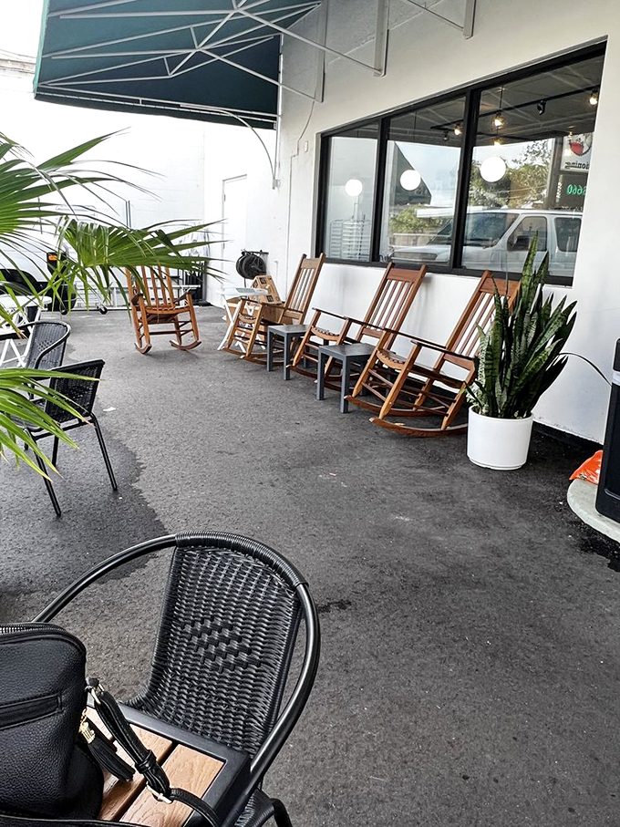 Rocking chairs and tropical plants create the perfect Florida porch setting for your morning coffee ritual.