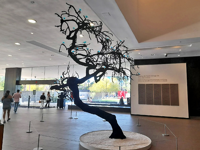 The twisted black tree sculpture greets visitors with its dramatic silhouette against the museum's clean lines.