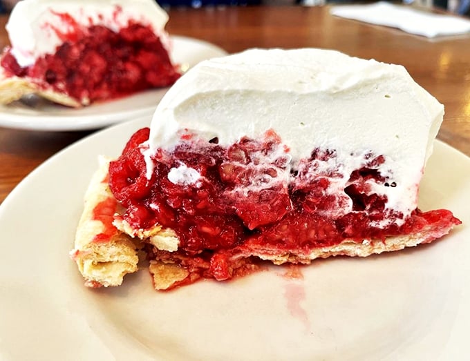 This raspberry cream pie looks like it just walked off the set of a food magazine photoshoot.