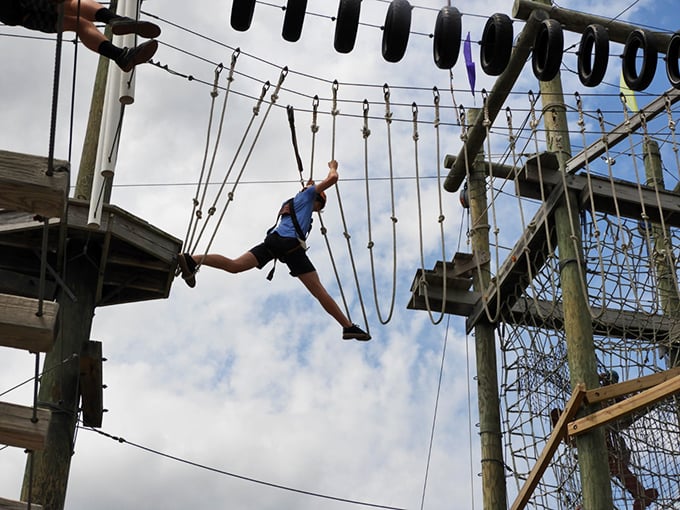 Swinging through the air with the greatest of ease? Well, maybe not ease, but definitely determination. Photo credit: Take Flight Aerial Adventure Park