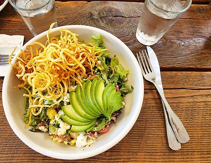 A salad that's dressed to impress, with avocado slices arranged like a green fan and crispy onions for the win. Photo credit: Paige A.