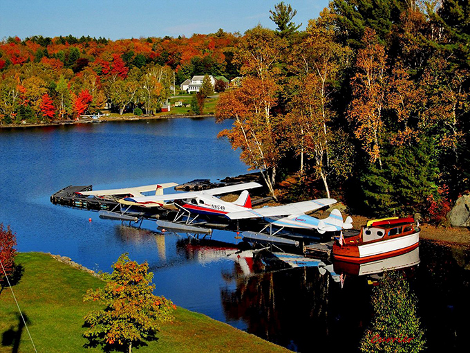 Fall colors frame this collection of seaplanes, proving that even parking lots can be postcard-worthy in Maine.