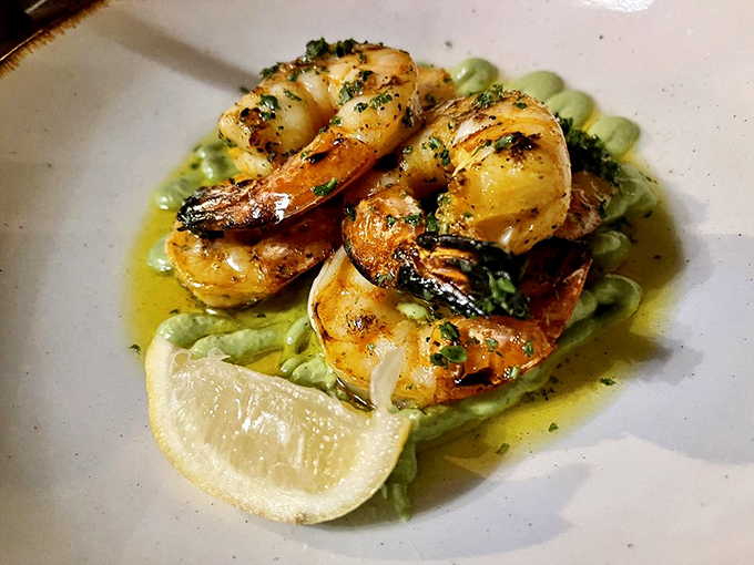 Succulent shrimp bask in herb-infused butter, proving seafood can hold its own at a steakhouse. Photo credit: Joseph N.
