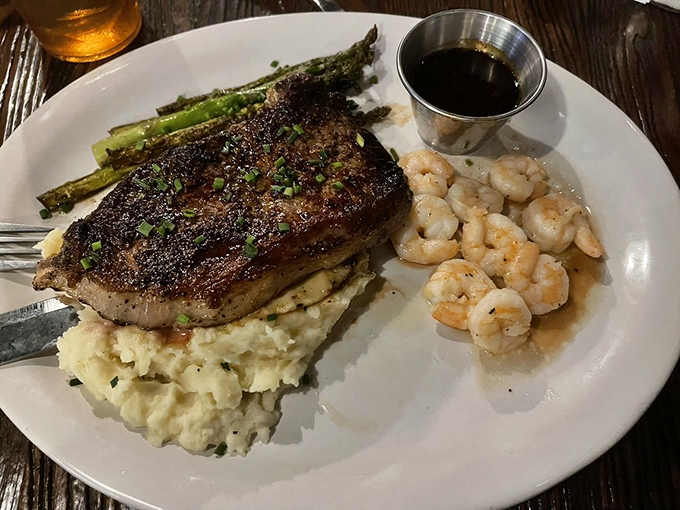 Surf meets turf in perfect harmony: a beautifully seared steak with plump shrimp and asparagus.