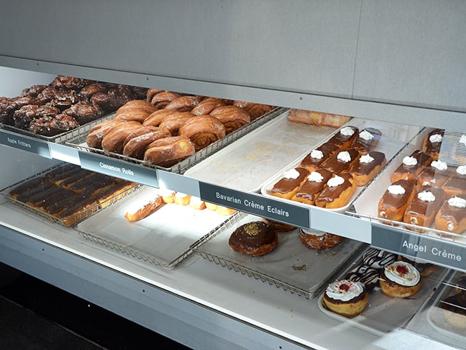 A rainbow of fried perfection! This display case is like the Louvre of donuts &ndash; each one a masterpiece in its own right.