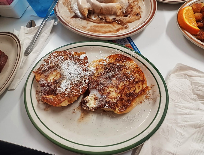 French toast that's more "ooh la la" than "oh la la." Crispy, custardy, and dusted with powdered sugar - it's breakfast bliss on a plate.