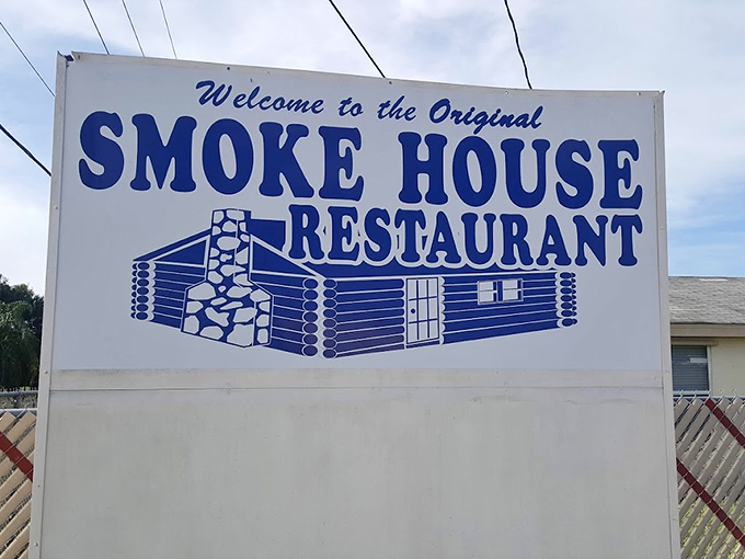 The Smoke House: where flavor goes to party! This sign promises a log cabin experience, minus the bears and plus the incredible eats.