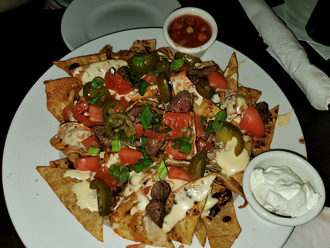Nachos gone rogue! These crispy, cheesy, tomato-topped rebels are staging a delicious flavor revolution on your taste buds. Photo credit: Ric Douglas