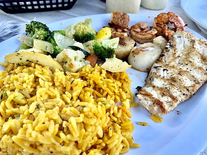 A plate that's got it all &ndash; grilled fish, succulent shrimp, and perfectly cooked rice. It's like a greatest hits album for your palate!