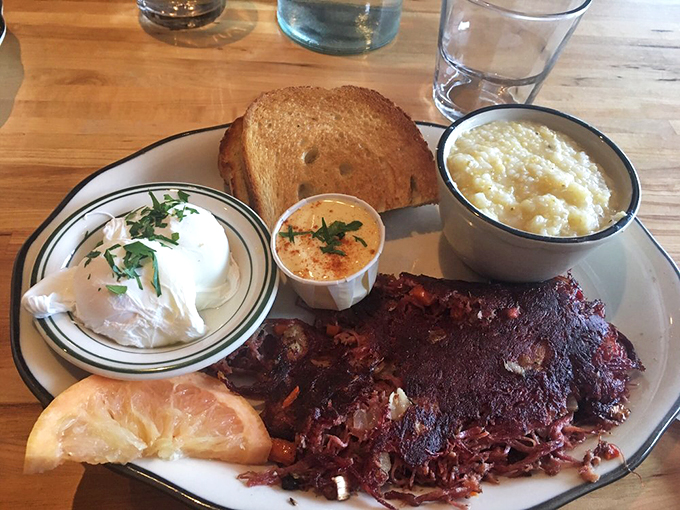 A breakfast plate that belongs in the comfort food hall of fame: creamy grits, poached eggs, and that famous hash.