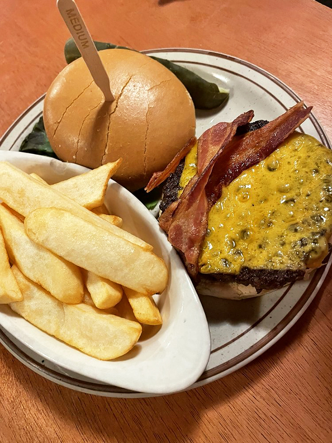 Hold onto your hats, folks! This burger's stacked higher than a cowboy's tall tale. It's a towering tribute to beef. Photo credit: Stacie W.