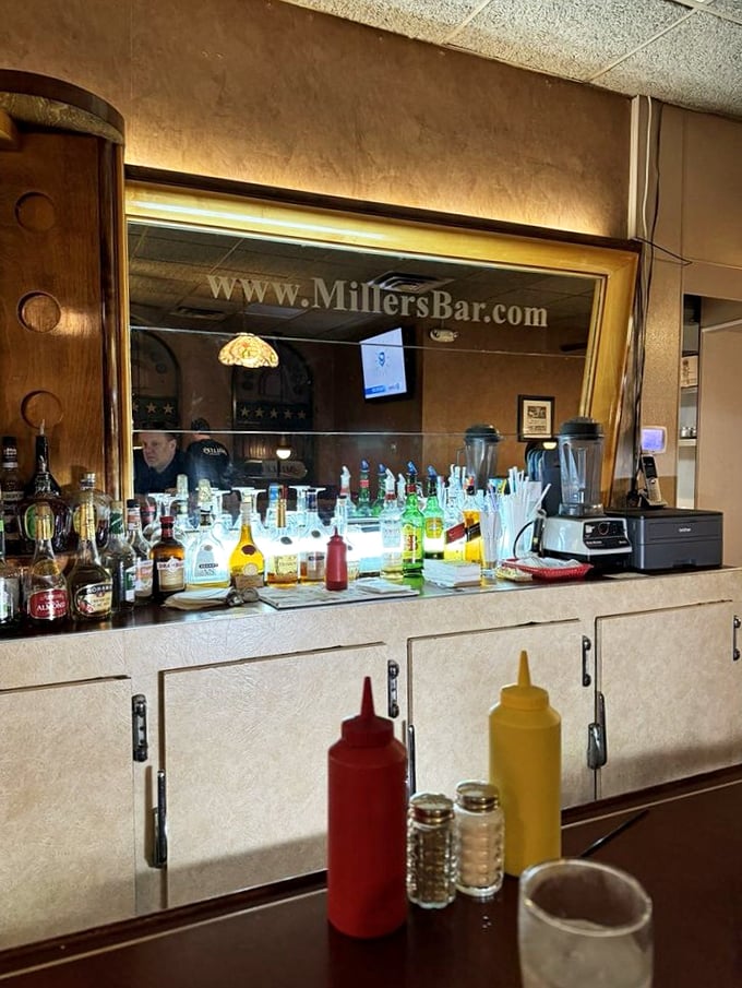 Bottles gleam like jewels behind the bar, but everyone knows the real treasure here comes on a bun.