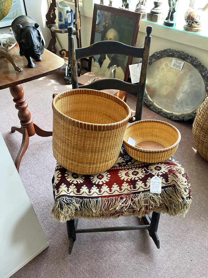 Nantucket-style baskets rest atop vintage textiles, bringing New England craftsmanship and comfort together beautifully.