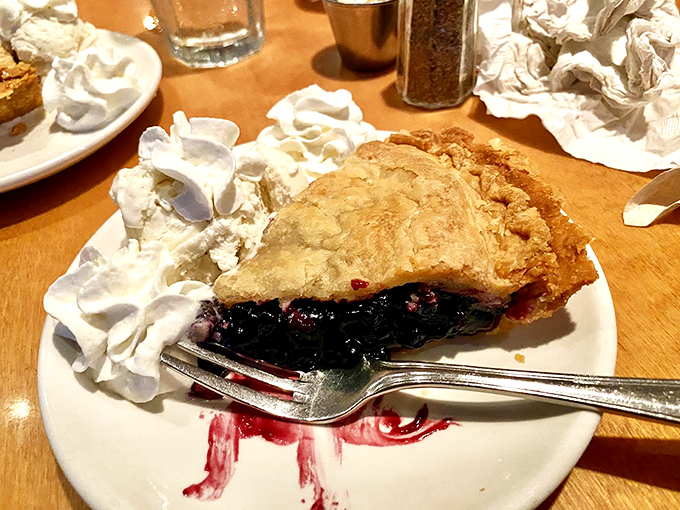 A slice of Maine blueberry pie that's so perfect, it might make you cry - complete with a cloud of whipped cream. Photo credit: Peter
